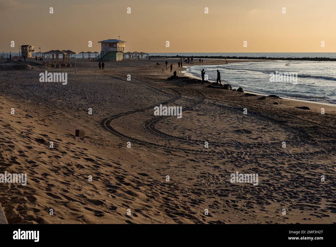 Haifa, Israel - January 20, 2023, Dado beach at sunset. People walk ...