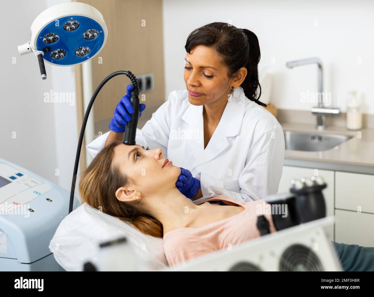 Woman receiving face ultrasound lifting procedure Stock Photo - Alamy