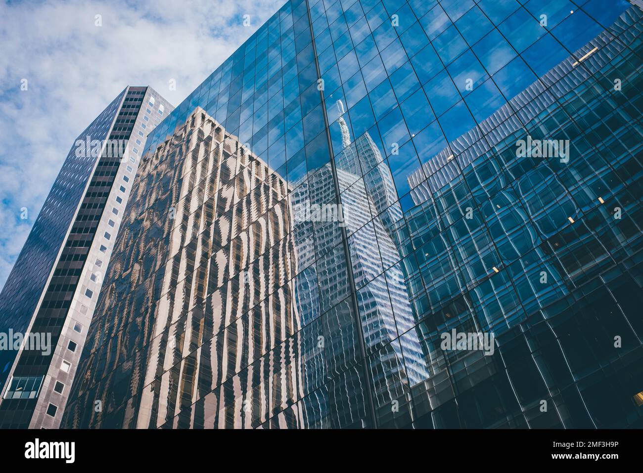 Skyline reflection off of office building window Stock Photo - Alamy