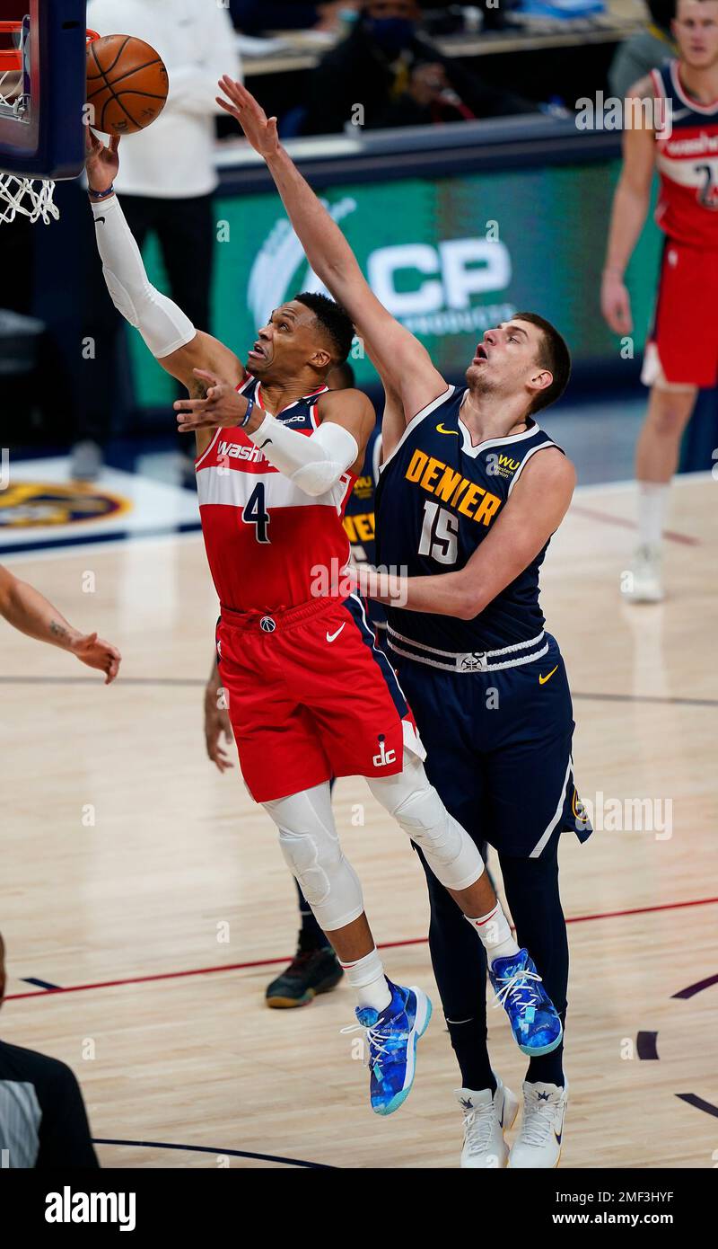 Washington Wizards guard Russell Westbrook (4) goes up for a shot against Denver Nuggets center ...