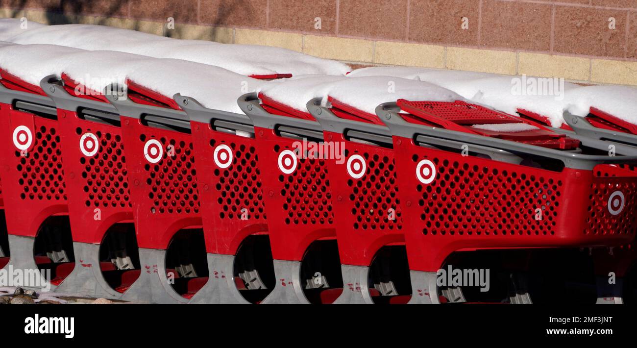 A blanket of snow covers shopping carts outside a Target store Thursday ...