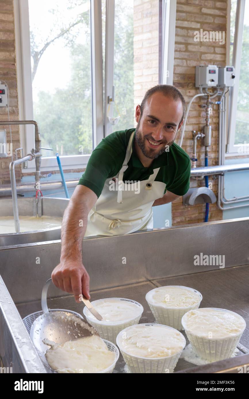 Man making ricotta cheese at cheese farm in Tuscany, Italy Stock Photo ...