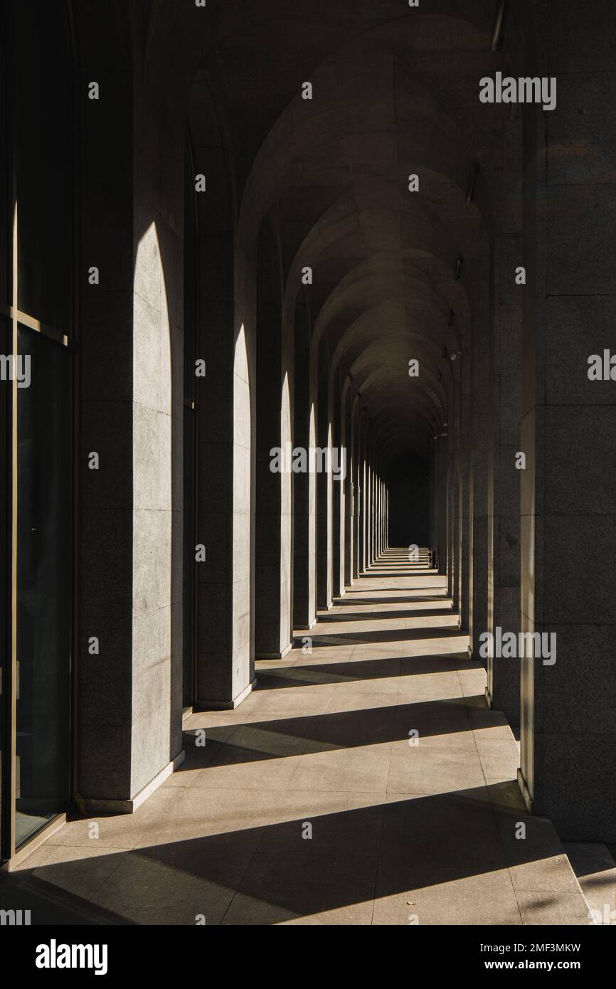 Corridor with rows of columns in sunlight Stock Photo - Alamy