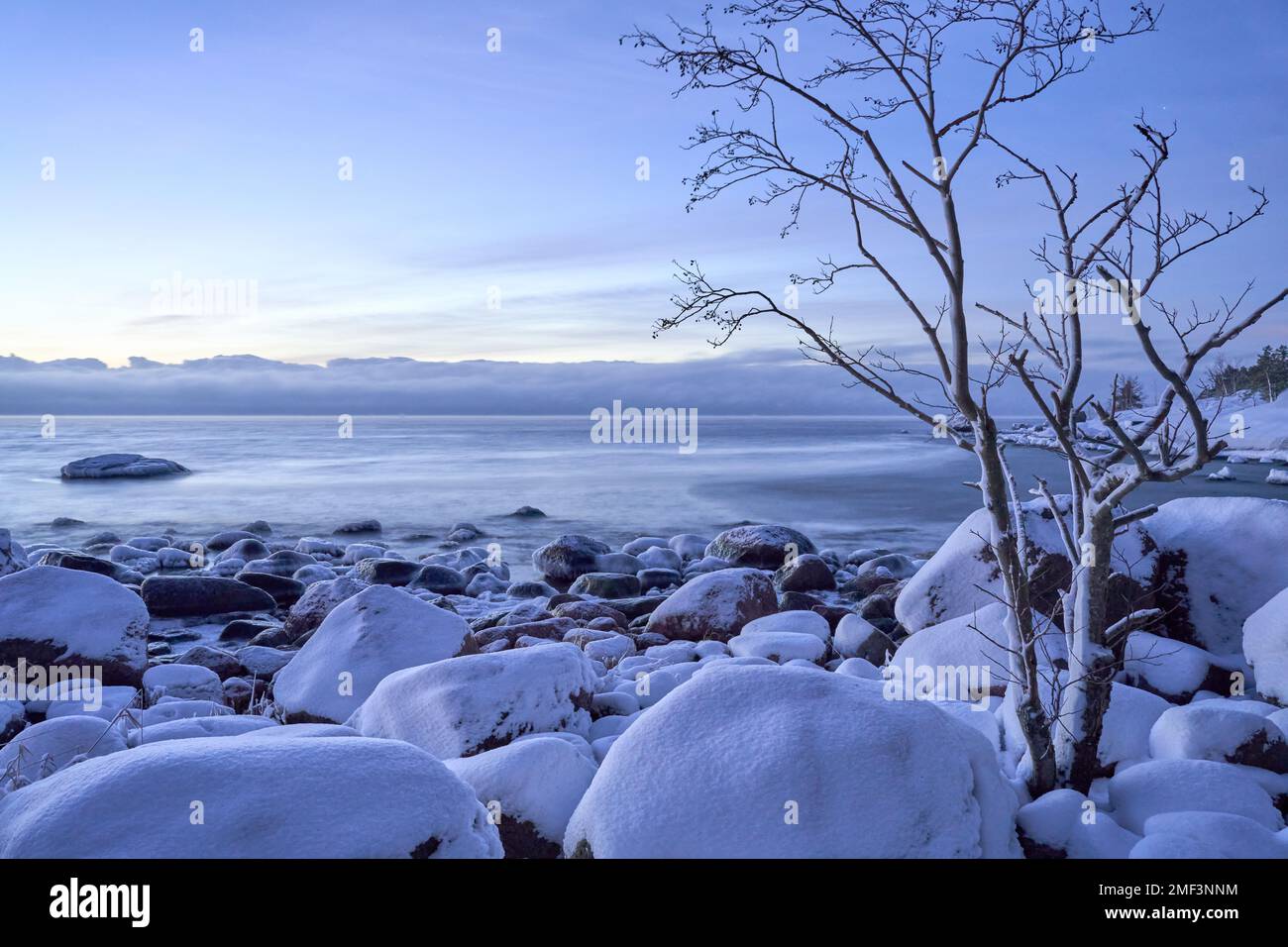 A view of a snowy and rocky lake coast Stock Photo - Alamy