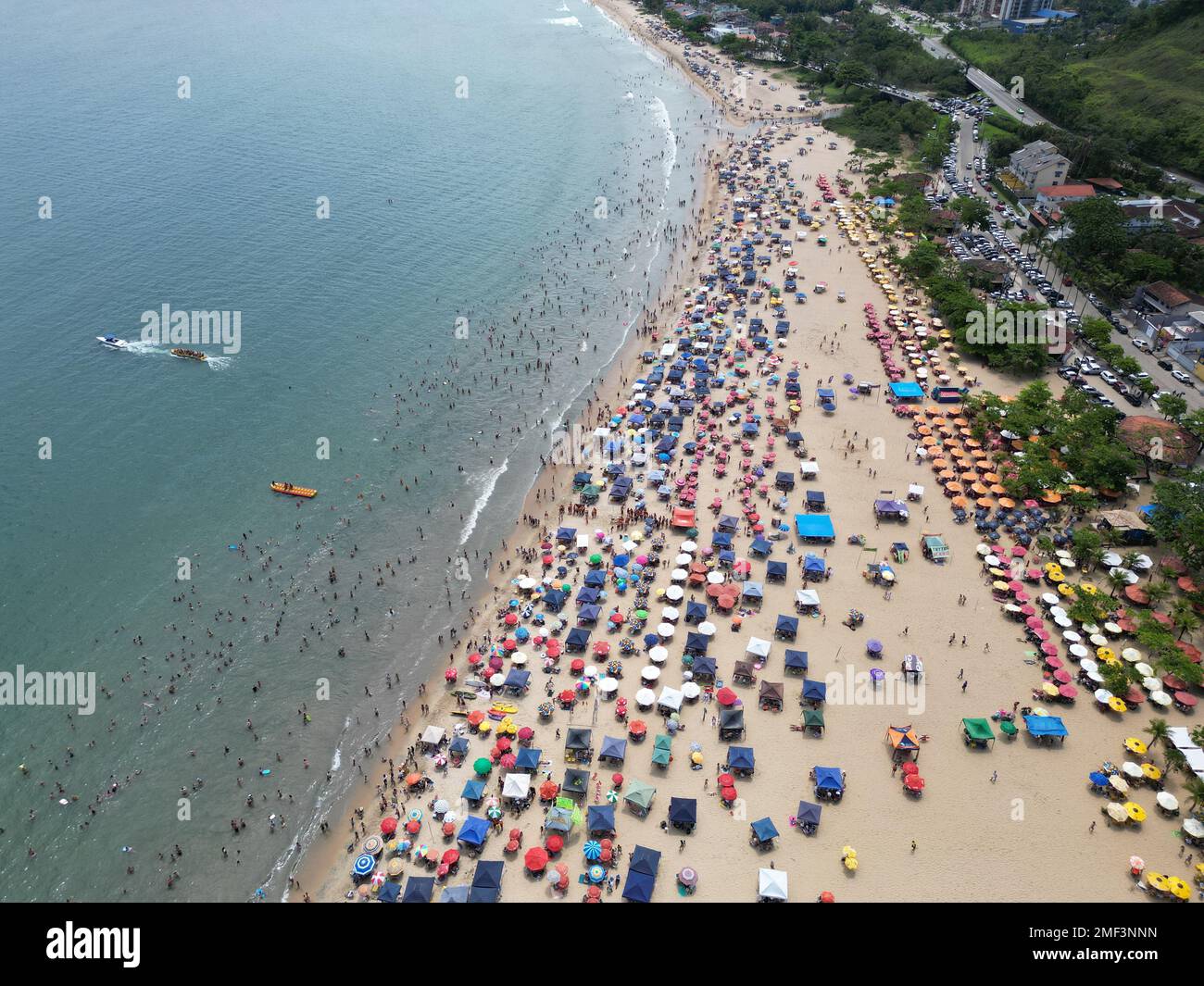 An aerial view of the people vacationing on the Mococa beach at daytime ...