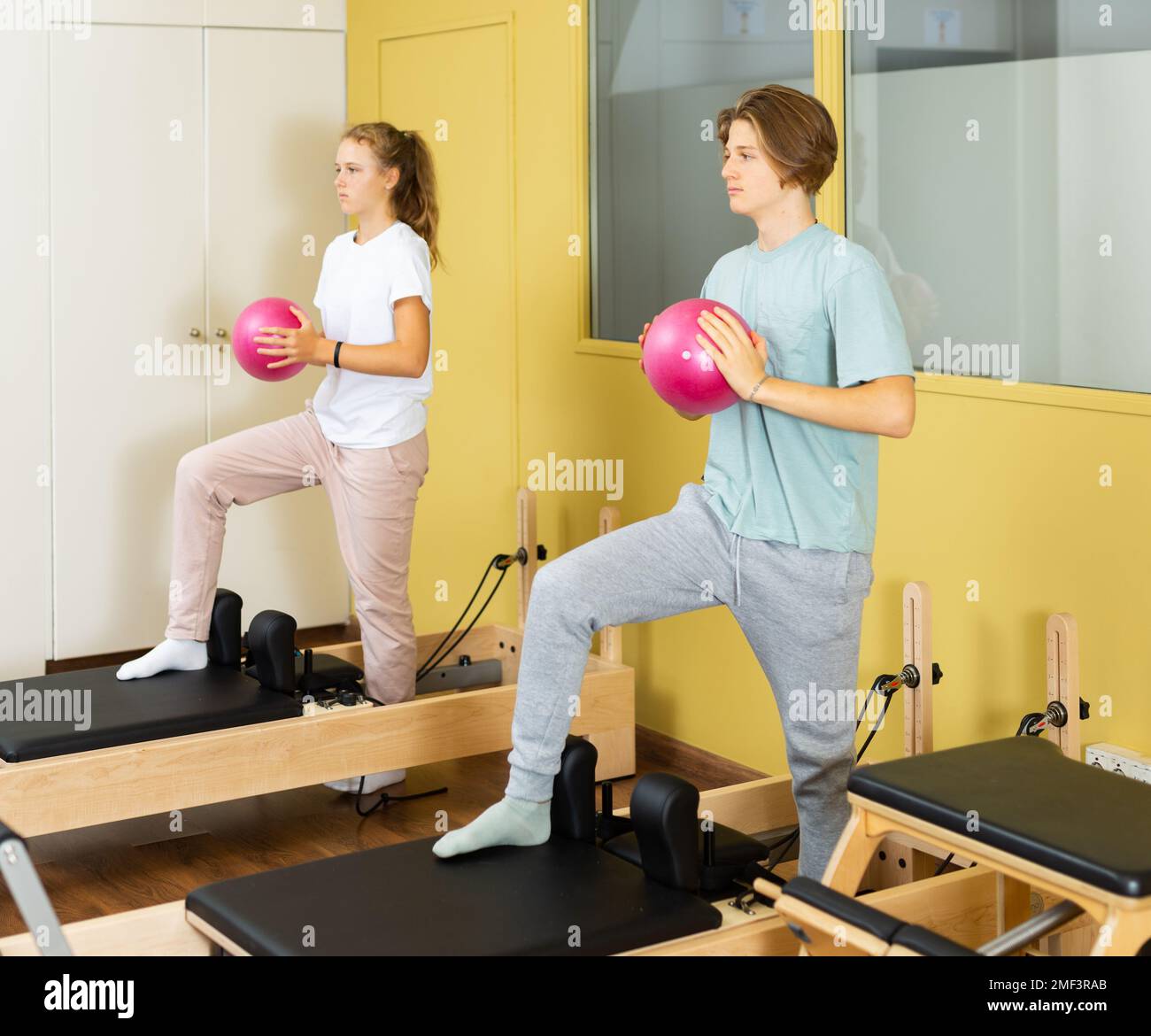 Teenagers training pilates in gym Stock Photo - Alamy