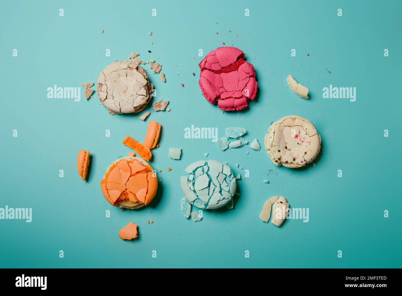 Close-up of macaroons of different colors in blue background. Culinary ...