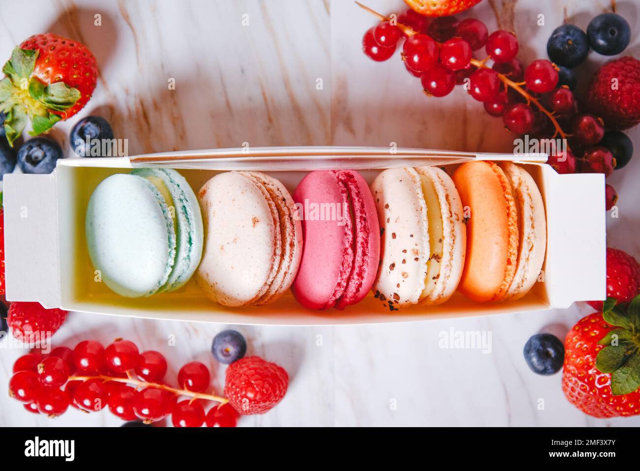 Macaronis in a white box with a transparent window. Color dessert, pink ...