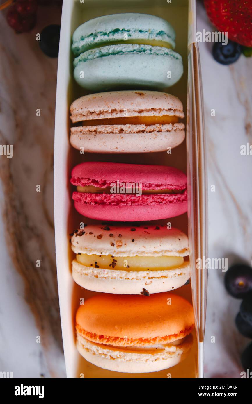 Macaronis in a white box with a transparent window. Color dessert, pink ...
