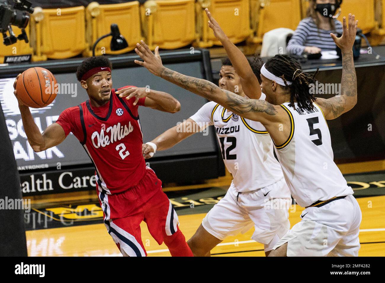 Mississippi's Devontae Shuler, left, passes the ball around Missouri's ...