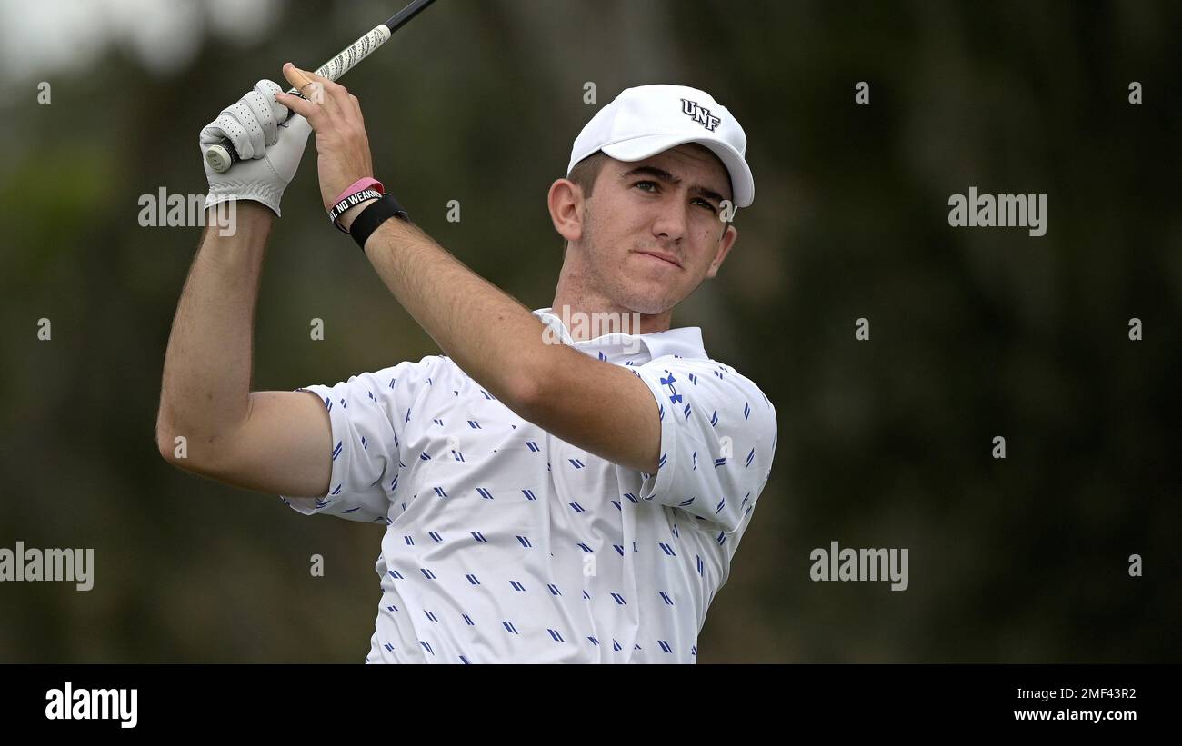 Robbie Higgins, of North Florida, watches his tee shot on the 16th hole ...