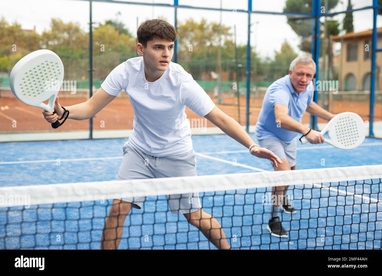 Man in sportswear playing padel tennis match during training on court ...