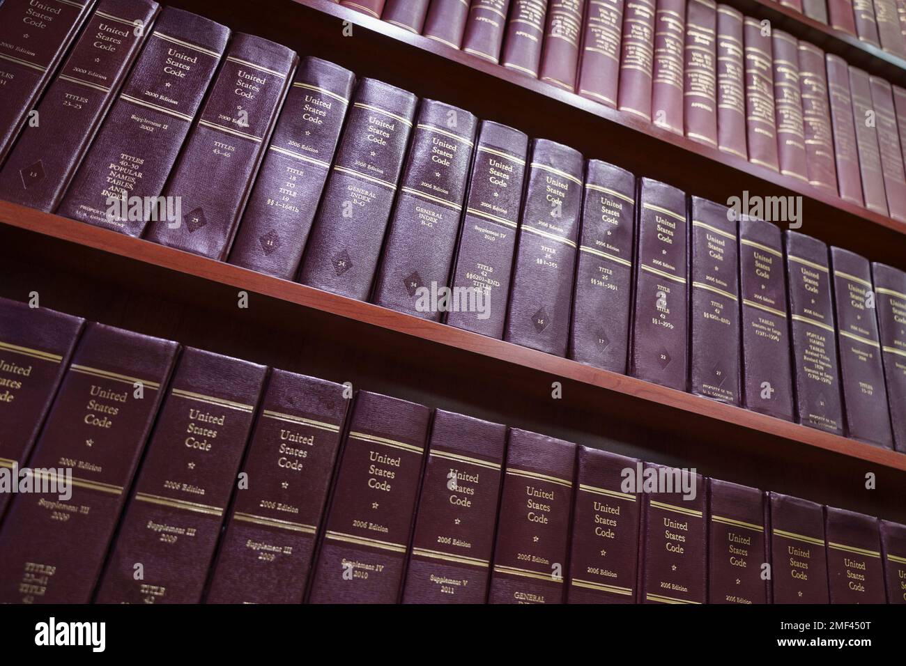Copies of the United States Code of federal laws fill a shelves in a ...