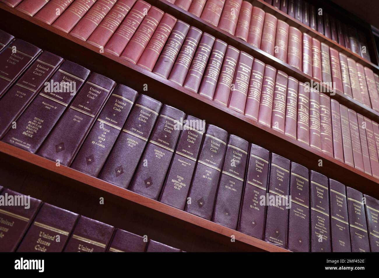 Copies of the United States Code of federal laws fill a shelves in a ...