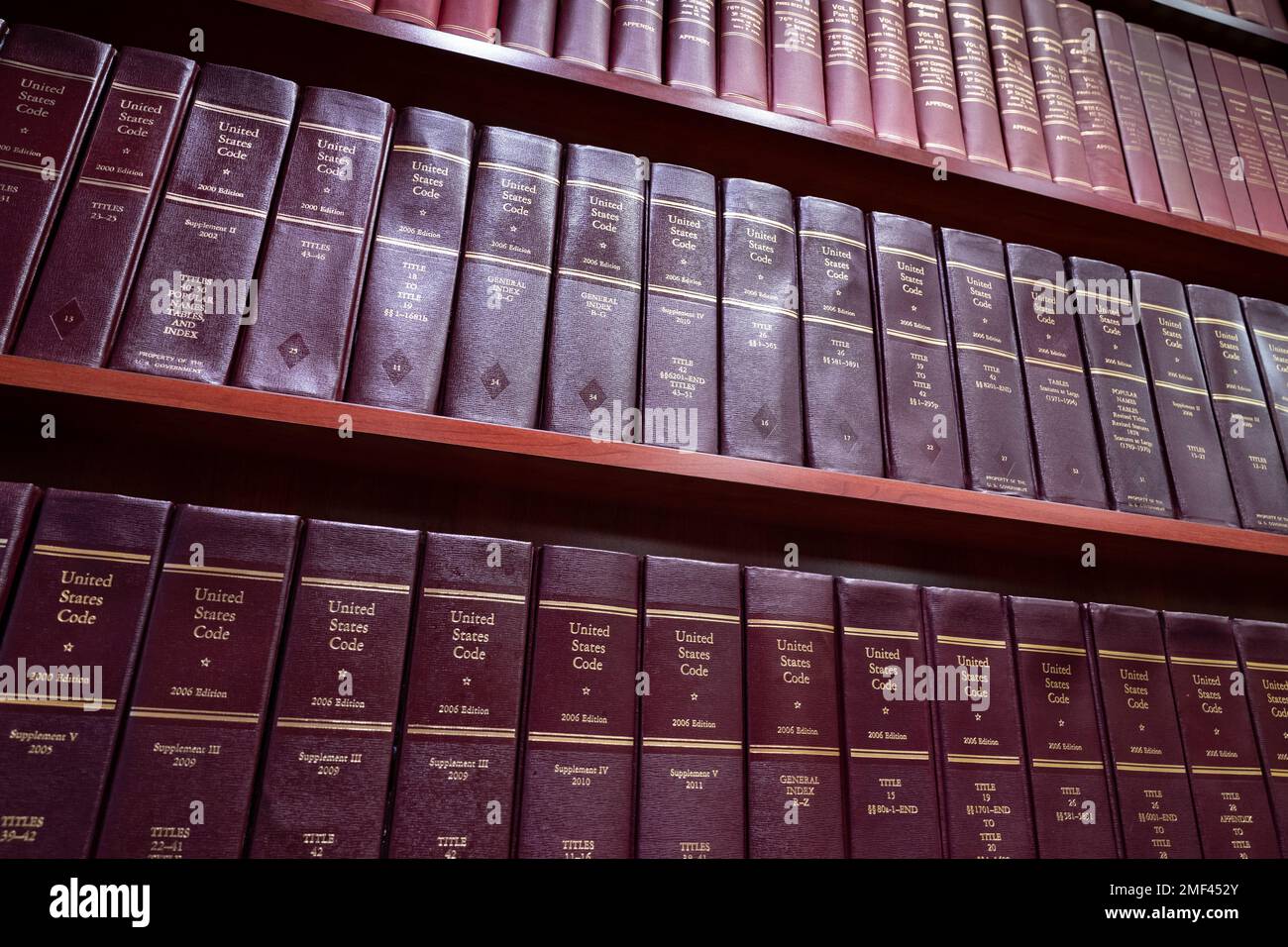 Copies of the United States Code of federal laws fill a shelves in a ...