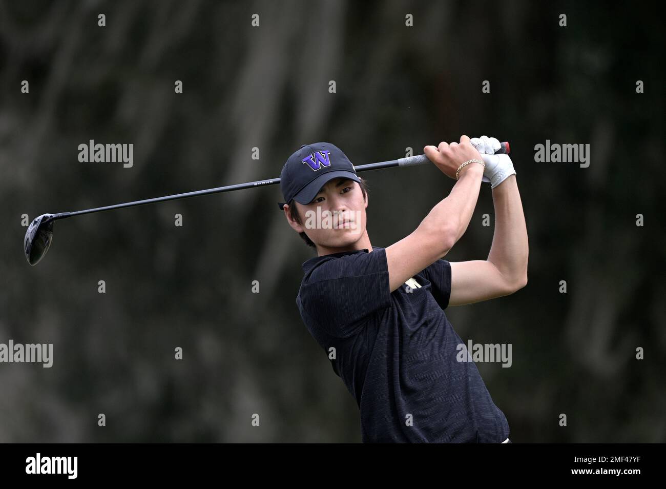 Taehoon Song, of Washington, watches his tee shot on the 16th hole ...