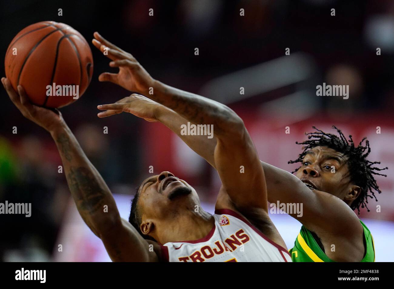 Southern California guard Isaiah White, left, keeps the ball away from ...