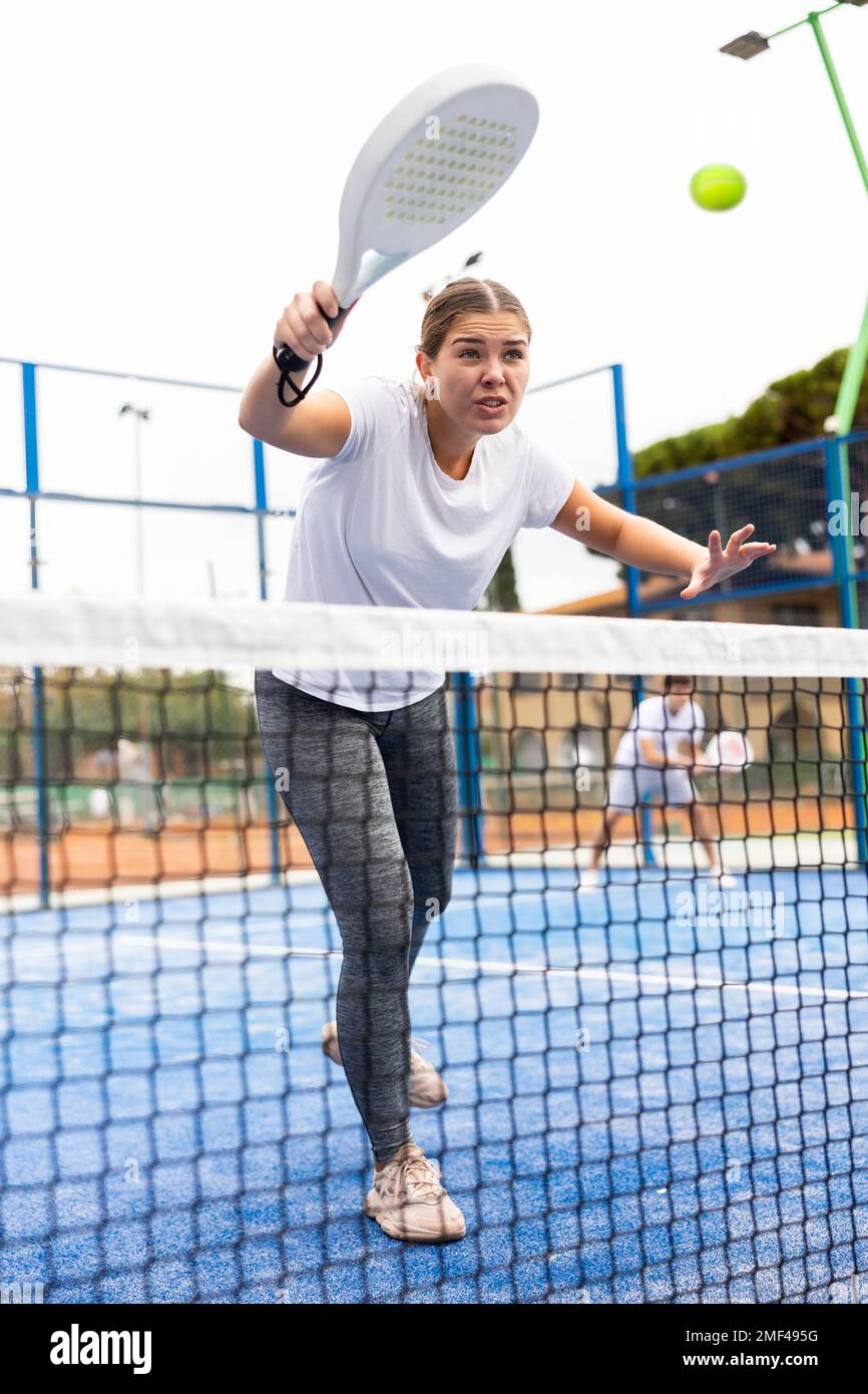 Young girl paddle tennis player performing forehand Stock Photo - Alamy