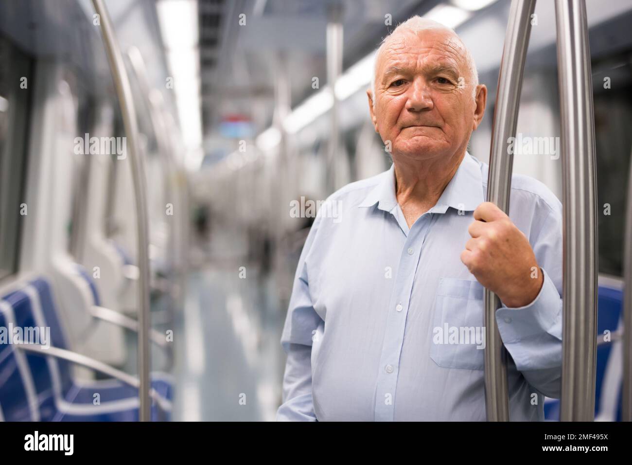 Elderly man in subway train Stock Photo - Alamy