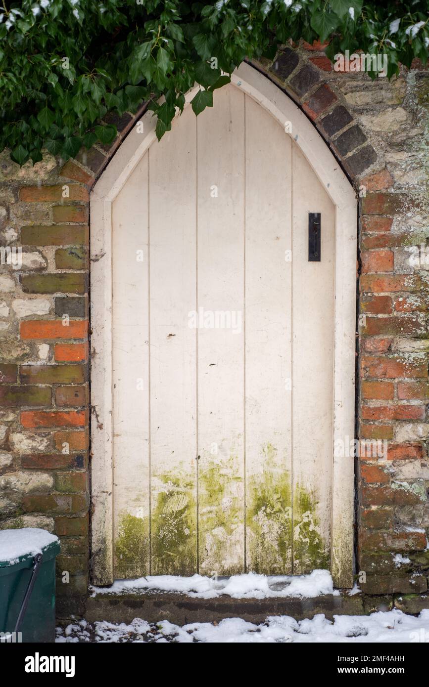 White arched door in a brick wall Stock Photo - Alamy