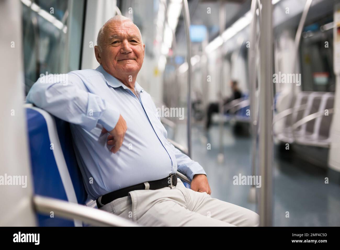 Senior man in metro train Stock Photo - Alamy
