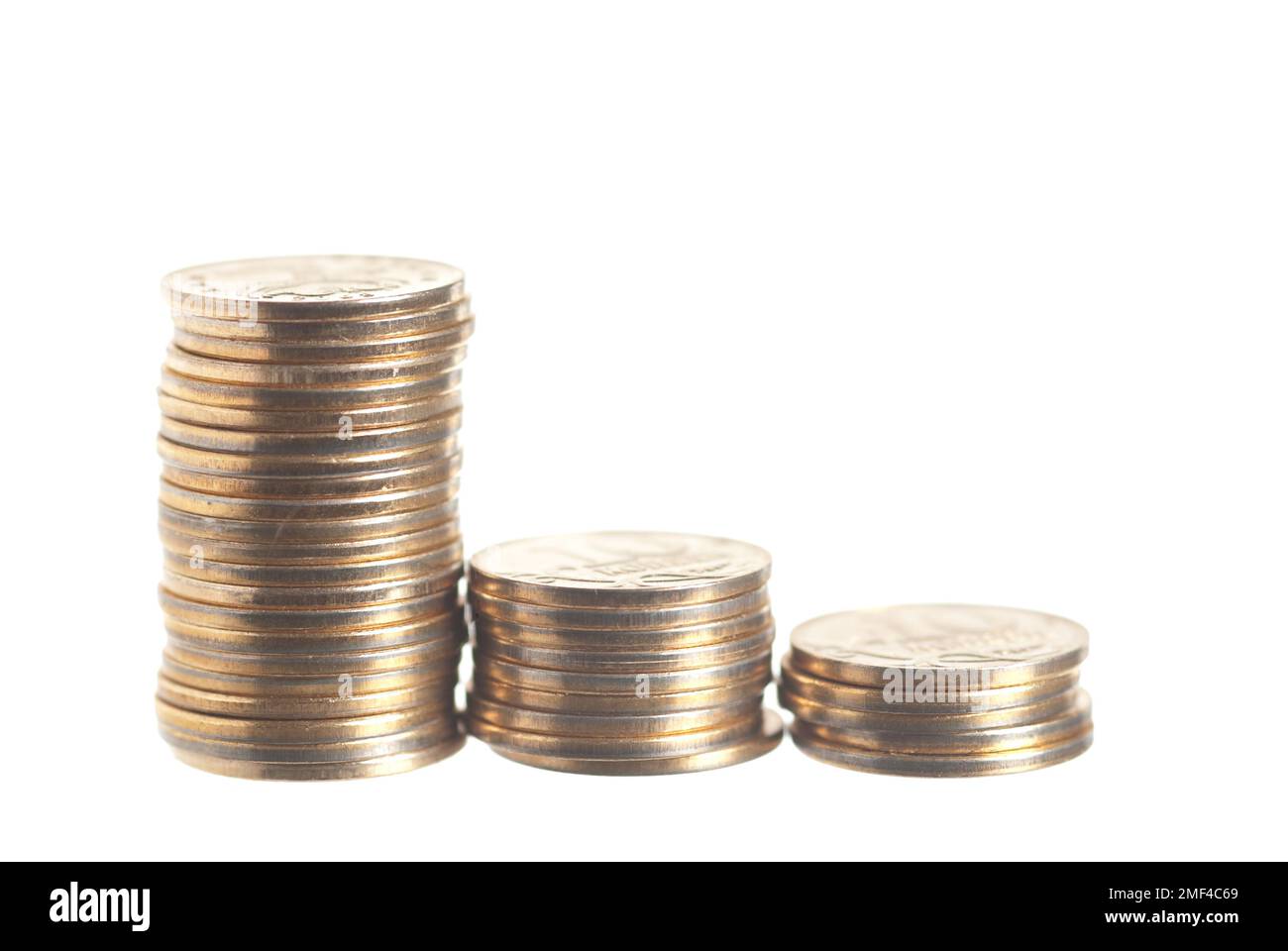 Three stacks of coins on white Stock Photo - Alamy