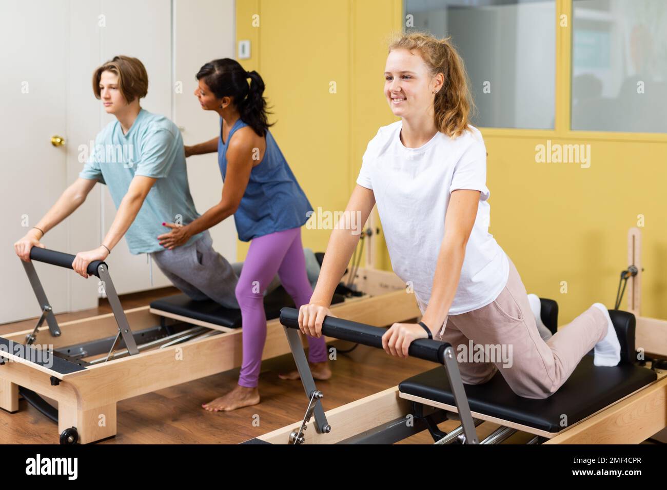 Pilates girl in reformer teaser exercise at sport gym Stock Photo - Alamy
