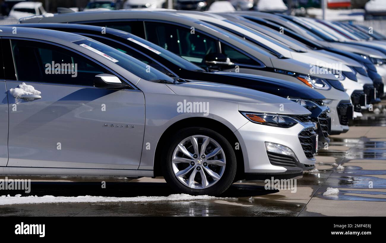 A long line of unsold 2021 sedans sits at a Chevrolet dealership Sunday ...