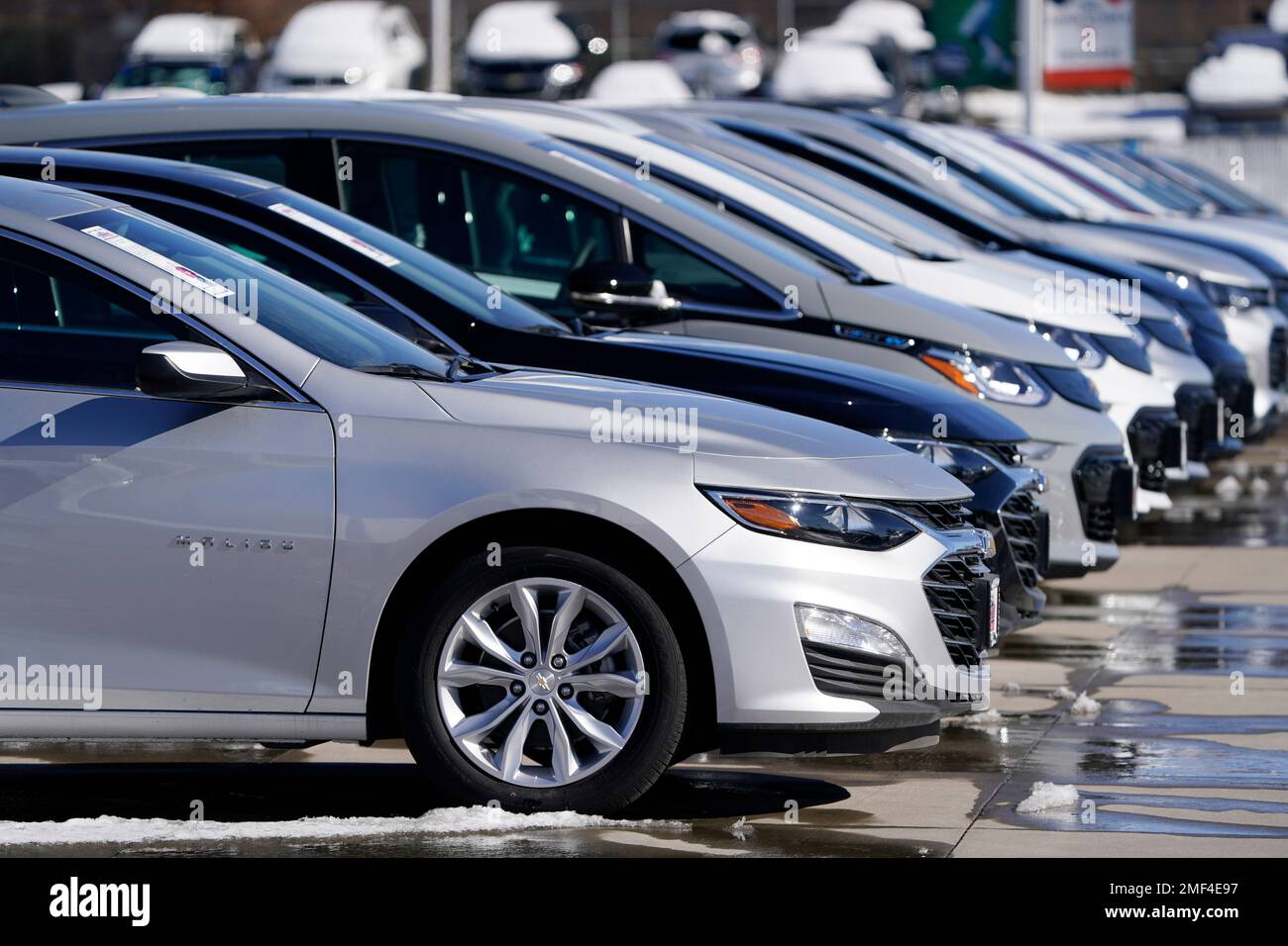 A long line of unsold 2021 sedans sits at a Chevrolet dealership Sunday ...
