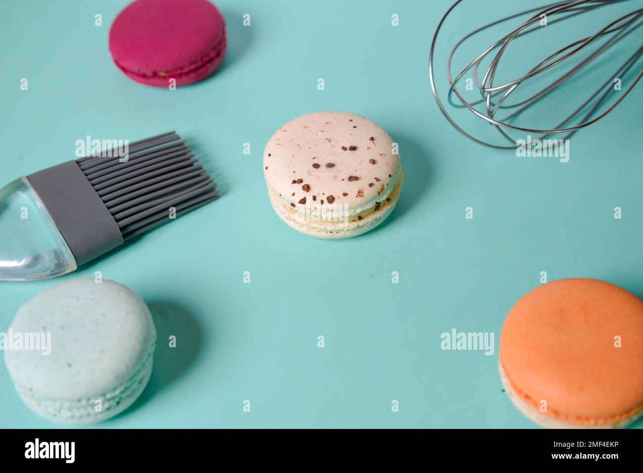 Colorful macarons. Small French cakes. Cooking, whisk, broken macarons ...