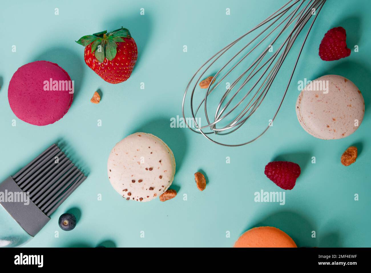 Colorful macarons. Small French cakes. Cooking, whisk, broken macarons ...