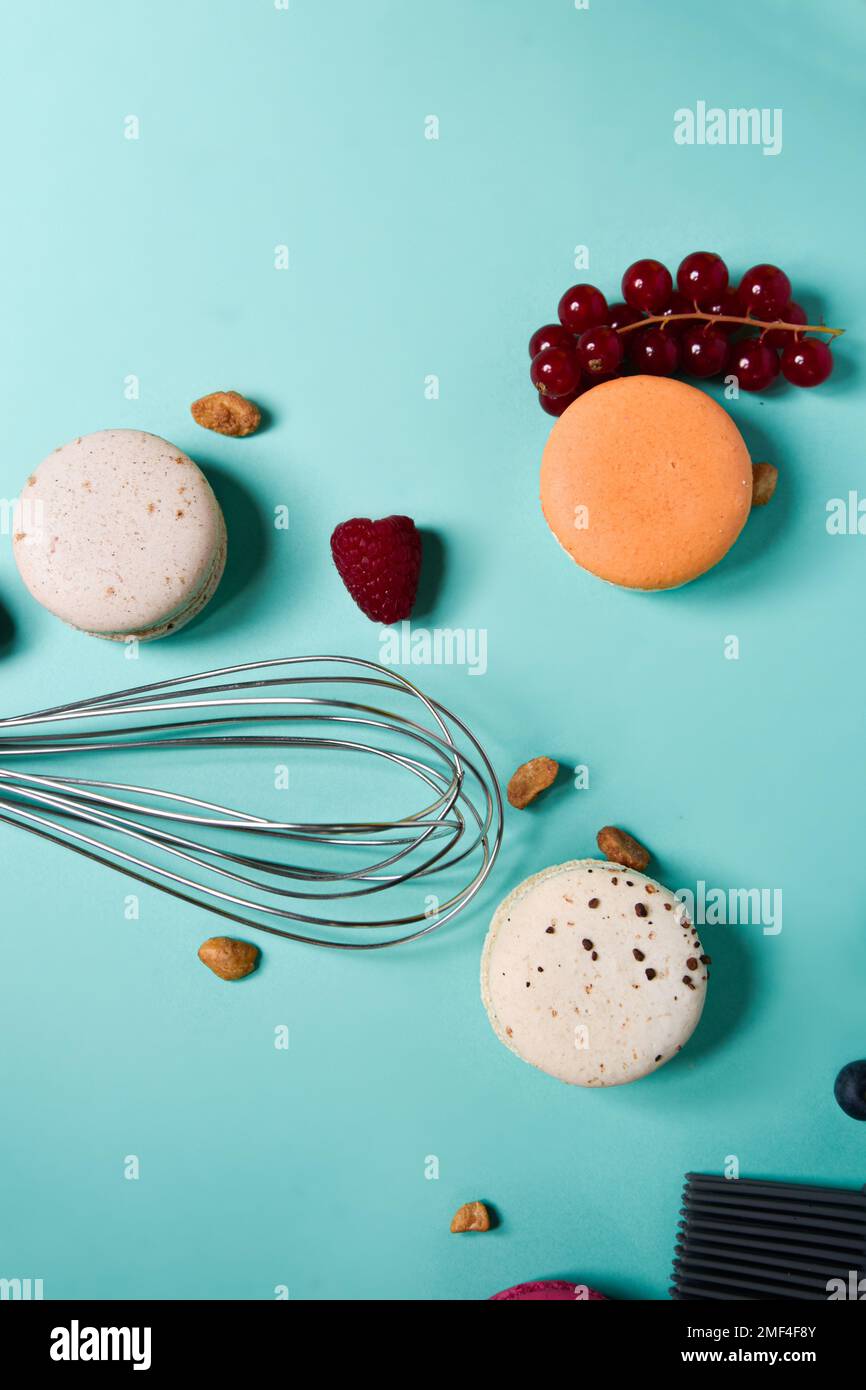 Colorful macarons. Small French cakes. Cooking, whisk, broken macarons ...