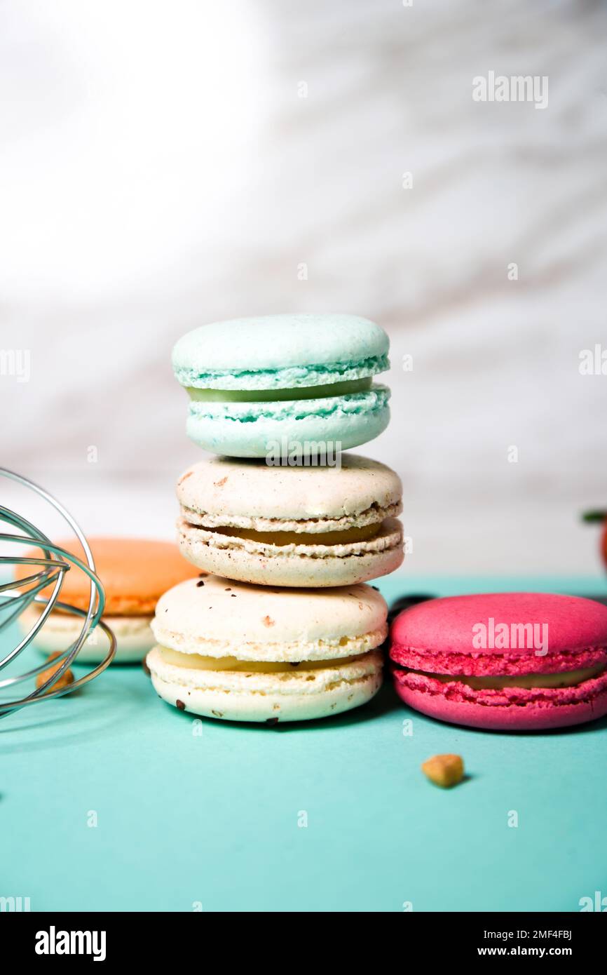 Colorful macarons. Small French cakes. Cooking, whisk, broken macarons ...