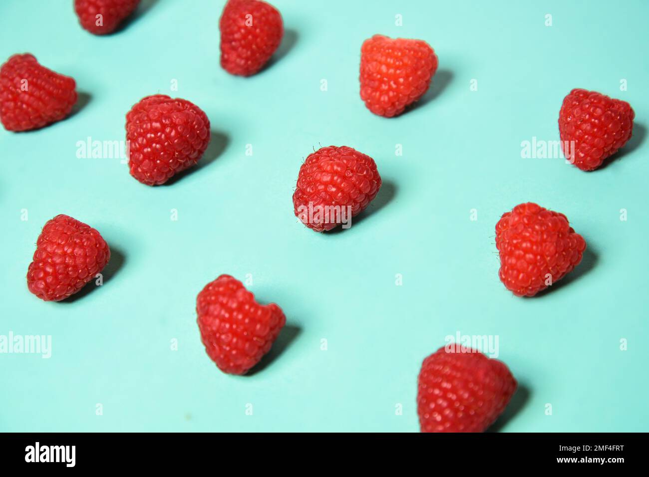 Raspberry pattern on the blue color of the lagoon. Fruits and healthy ...