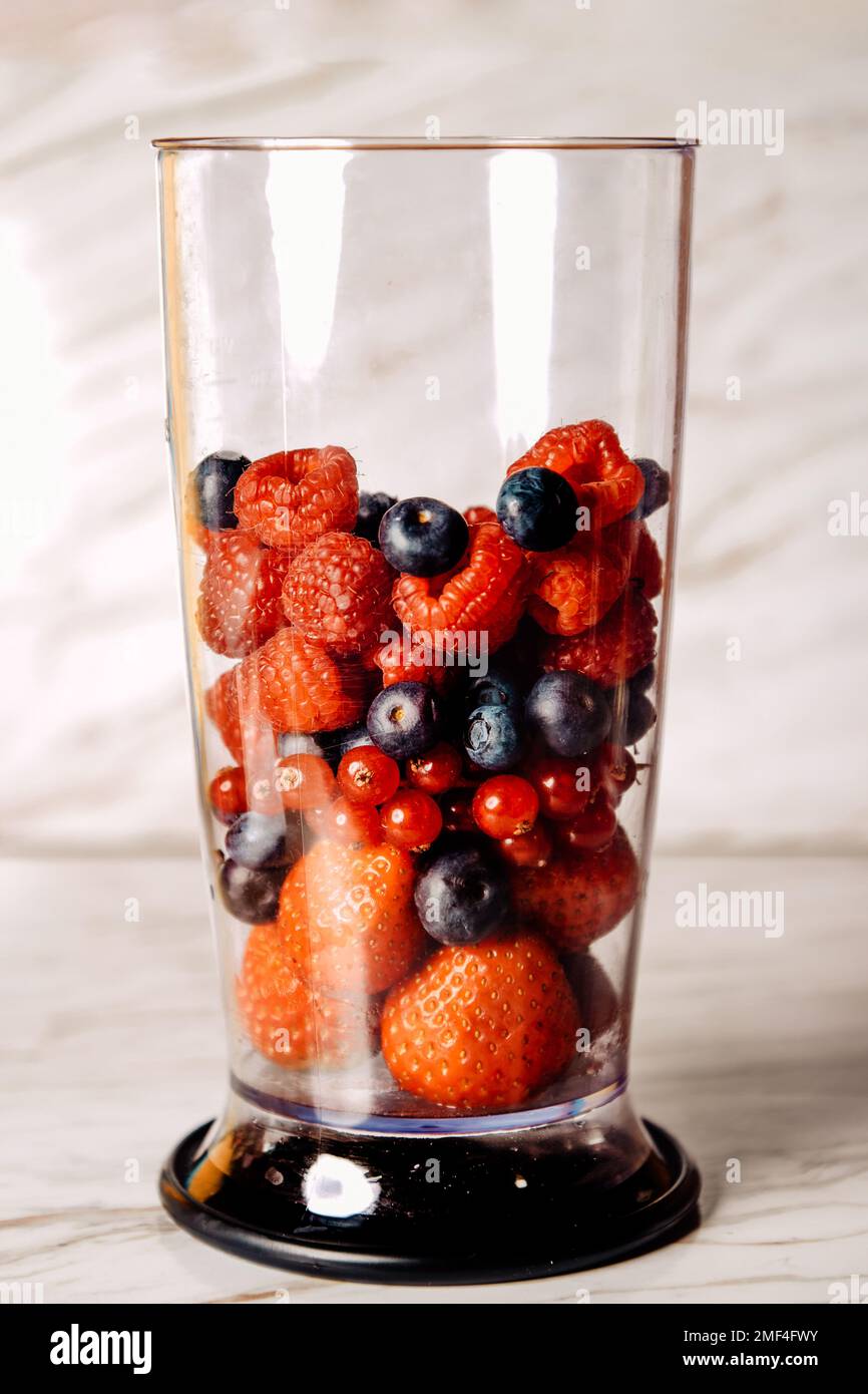 Fruit in a blender, mixer. Fruit cocktail and healthy food and drinks ...