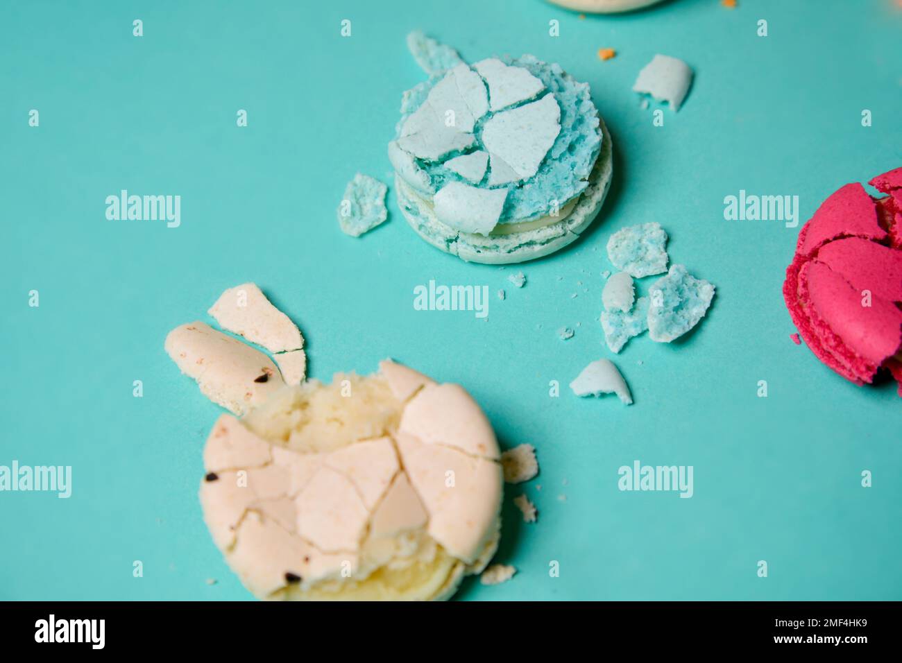 Close-up of macaroons of different colors in blue background. Culinary ...