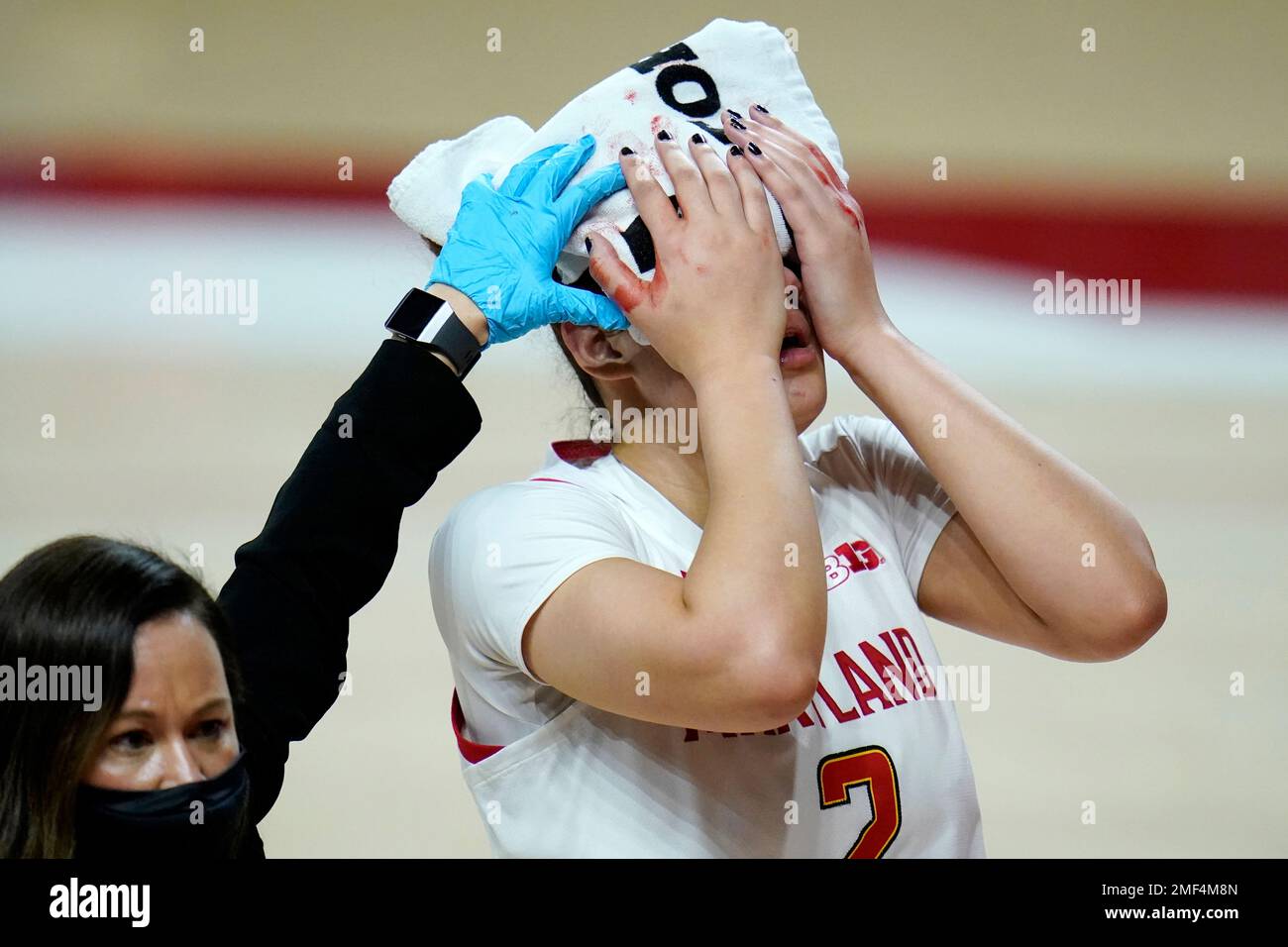 Maryland forward Mimi Collins, right, is helped off the court by ...