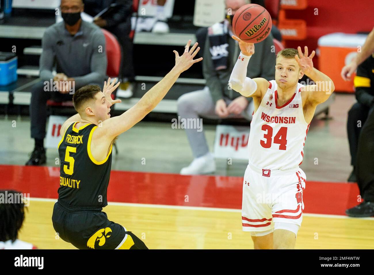 Wisconsin's Brad Davison (34) and Iowa's CJ Fredrick (5) during the ...
