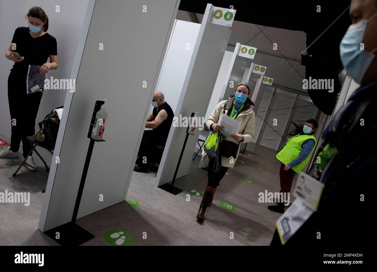 Stewards direct people to wait in rooms prior to receiving an injection ...