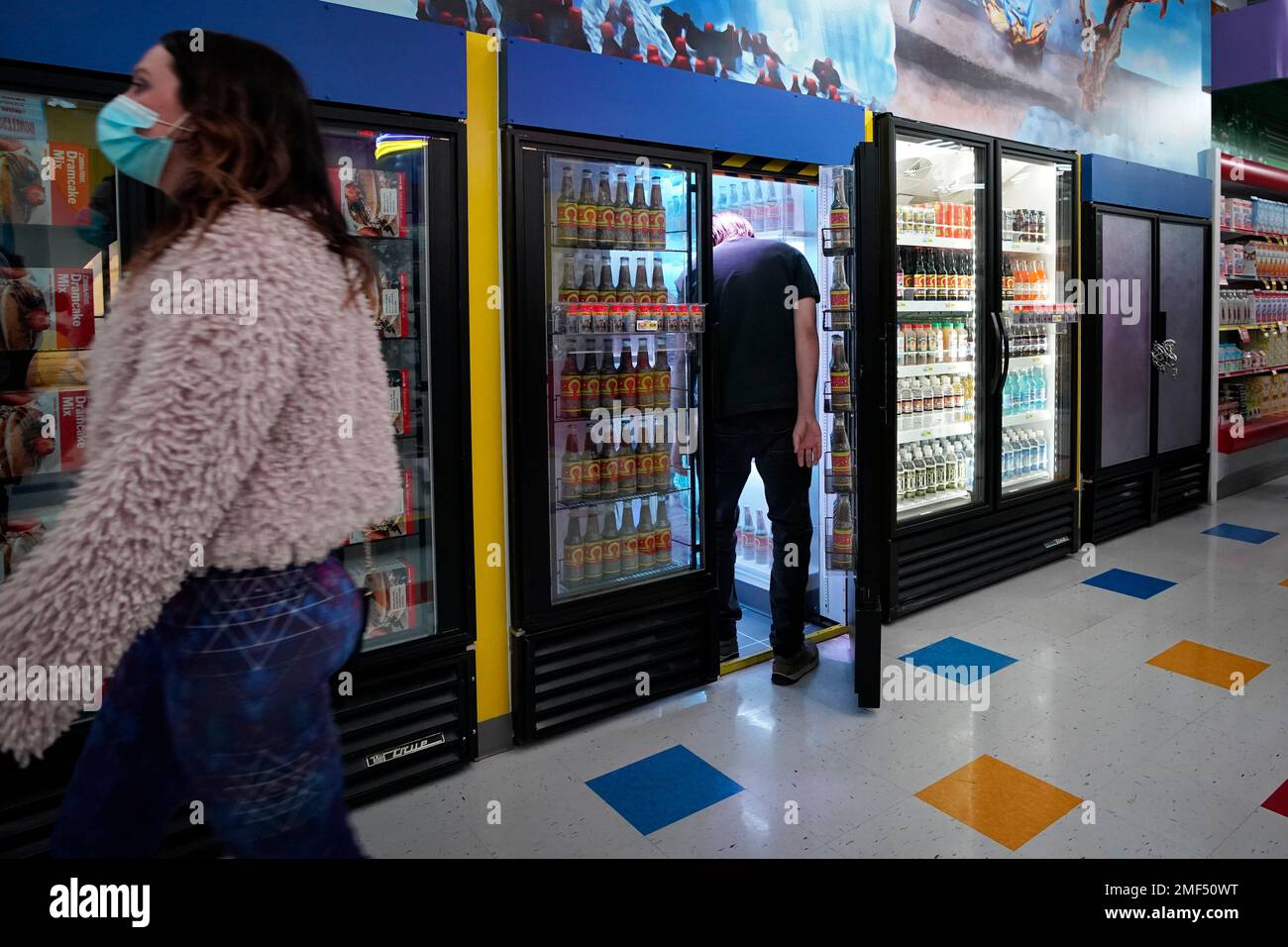 A person walks into a fake cooler that leads to a hidden hallway at ...