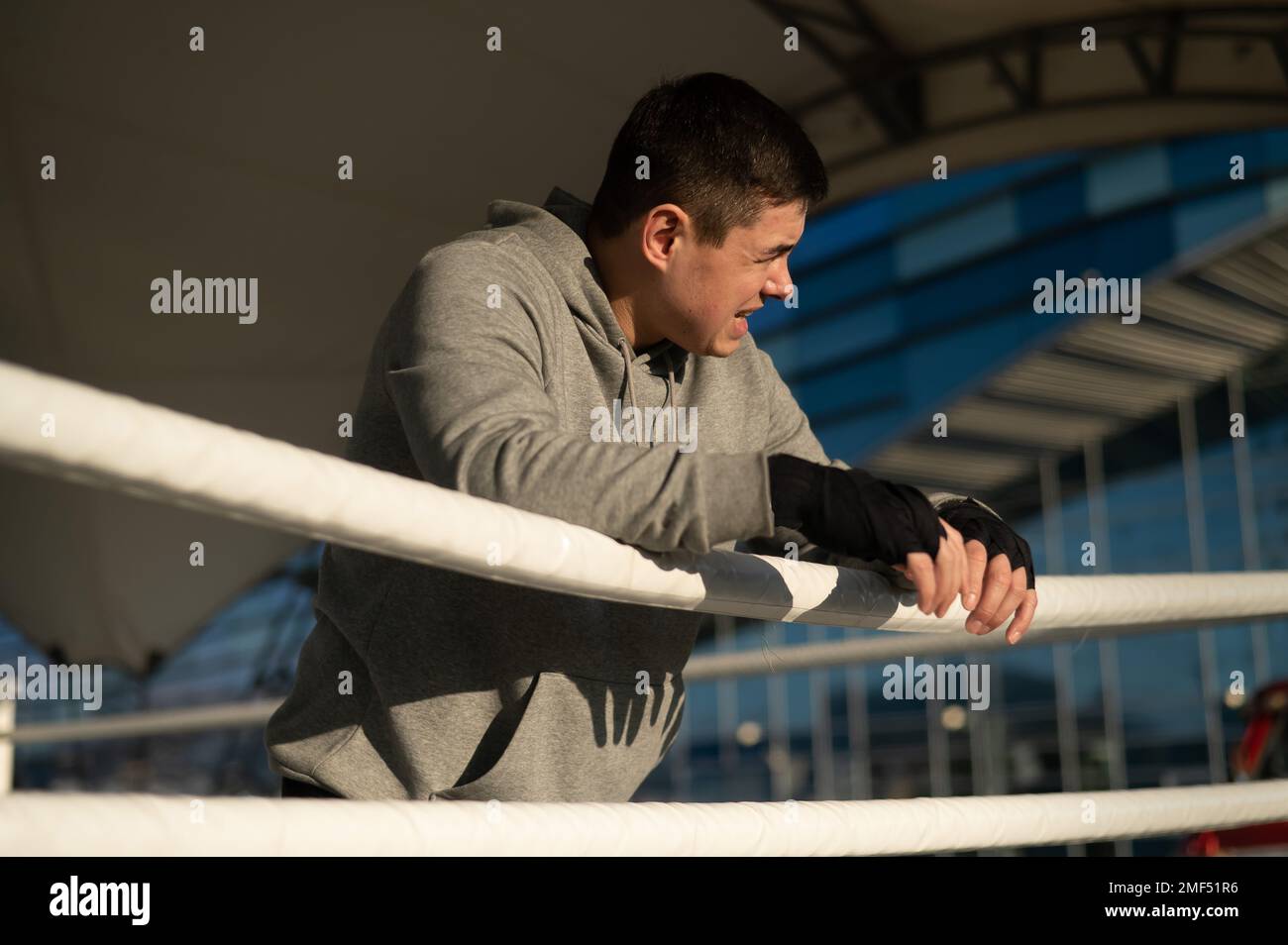 Caucasian male boxer resting in the ring outdoors Stock Photo - Alamy