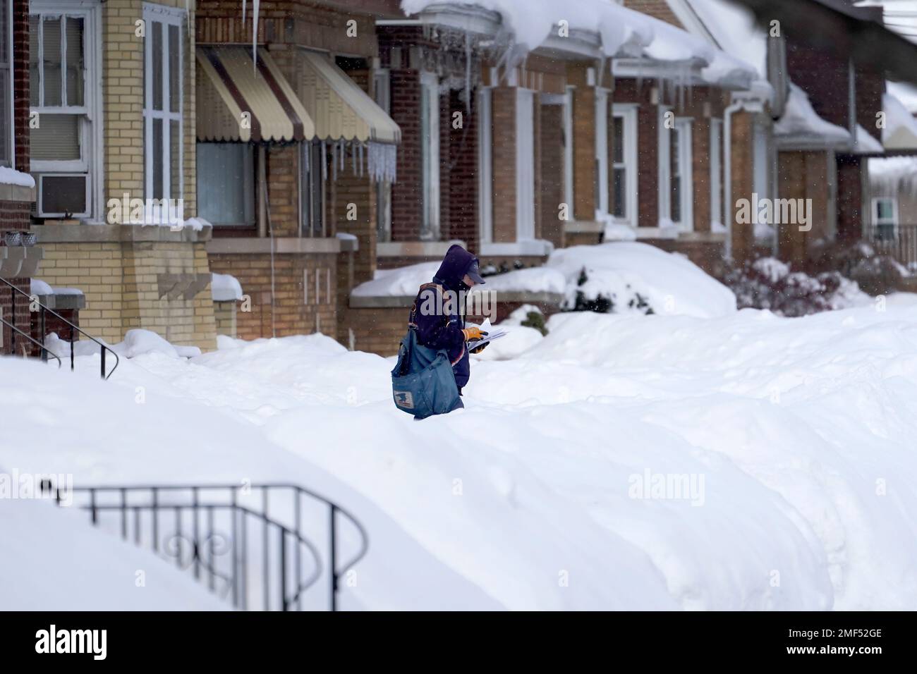 A United State Postal worker delivers the mail Thursday, Feb. 18, 2021 ...
