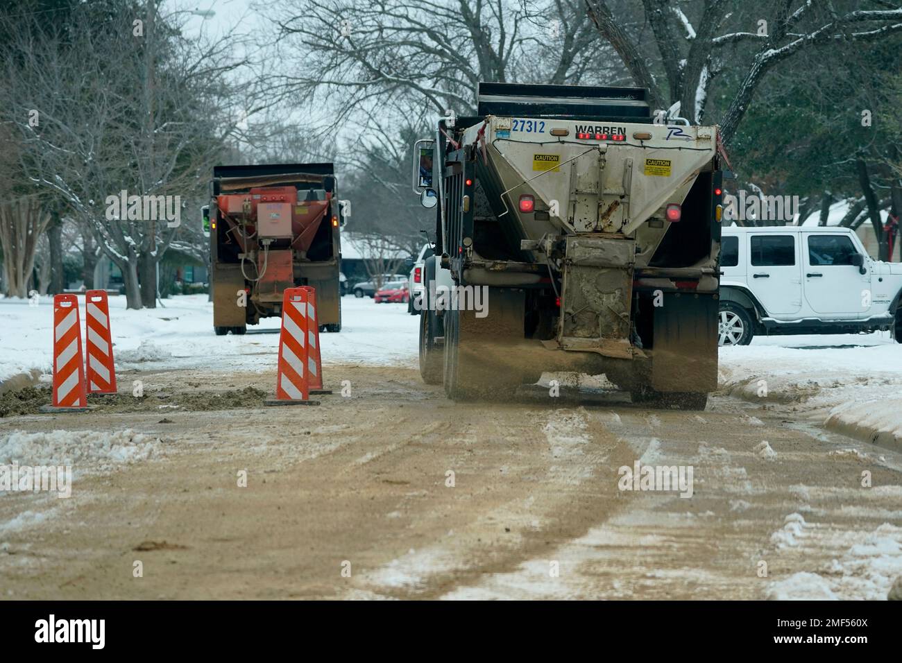 City work crews drop de-icing agent on a residential street in ...