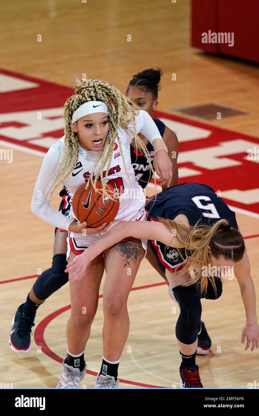 St. John's forward Rayven Peeples (20) untangles herself from ...