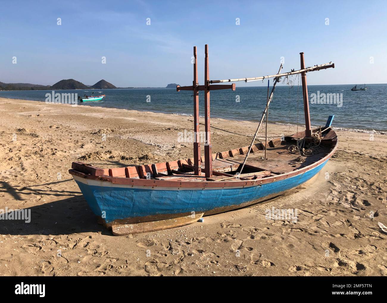 On the beach of Dolphin Bay, a fishing boat sits on the shore Sunday ...