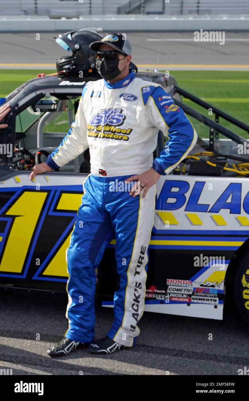 David Gilliland waits by his truck during NASCAR truck qualifying at ...