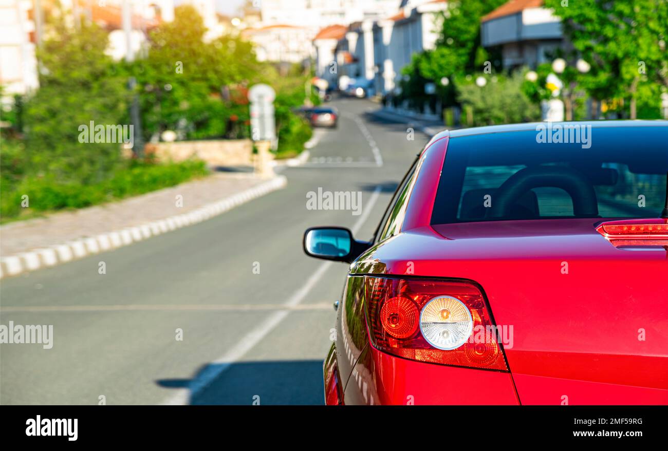 Red car on a city street Stock Photo - Alamy