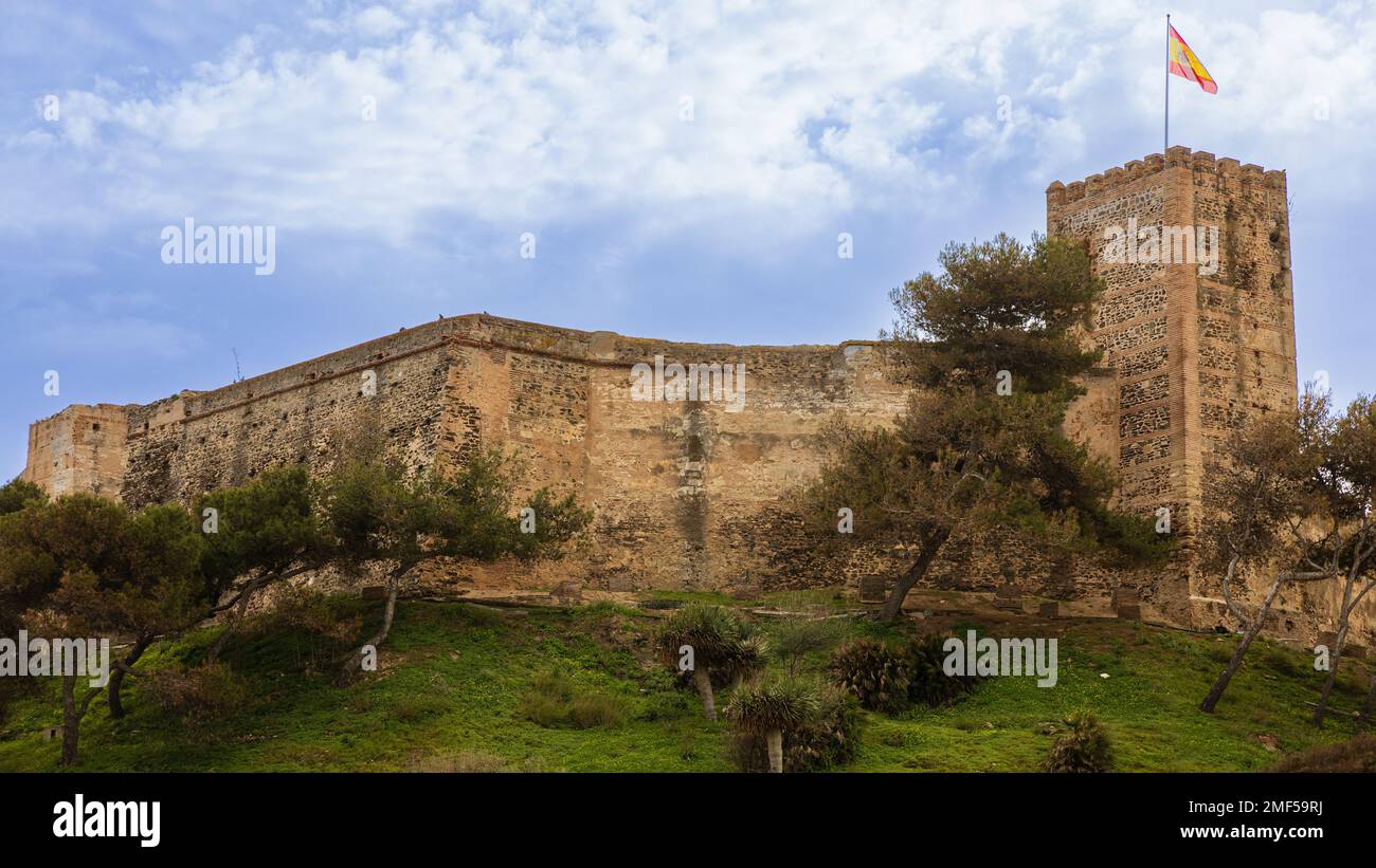 Medieval Sohail Castle exterior, walls and towers with Spanish flag ...