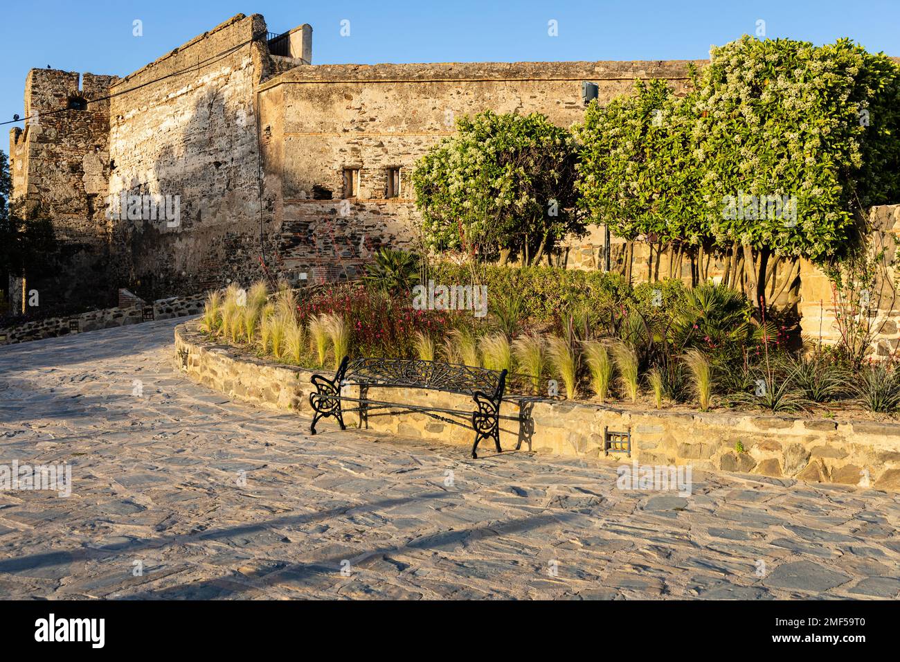 Public park and fragment of Sohail Castle in the background. Fuengirola ...