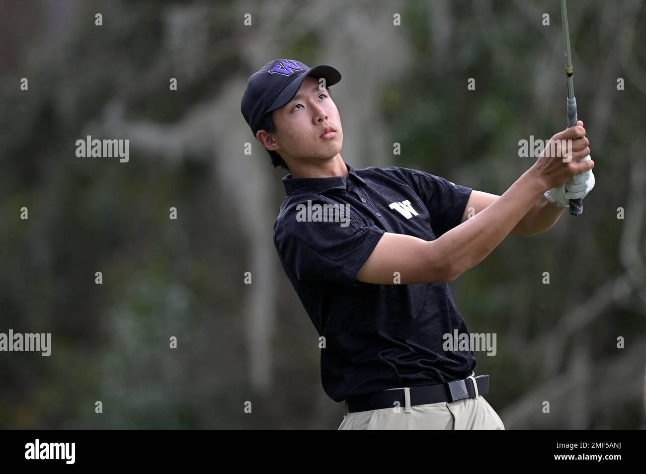 Chuan-Tai Lin, of Washington, watches his tee shot on the eighth hole ...
